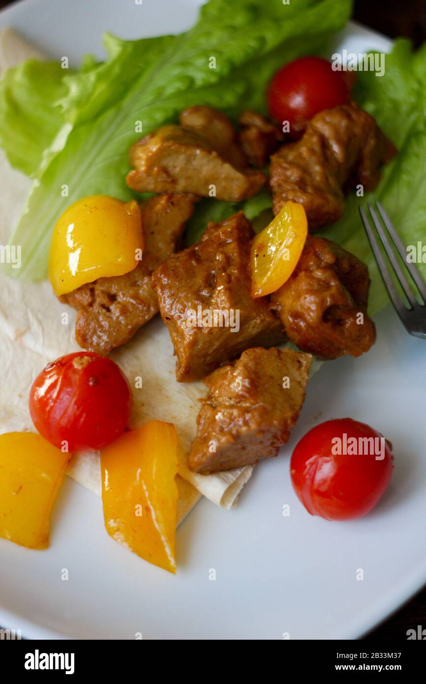 Seitan on white plate with the vegetables Stock Photo - Alamy