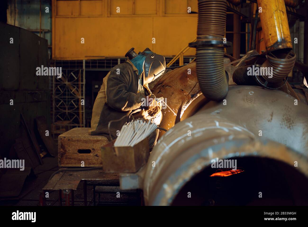 Welder works with metal on factory, welding skill Stock Photo - Alamy