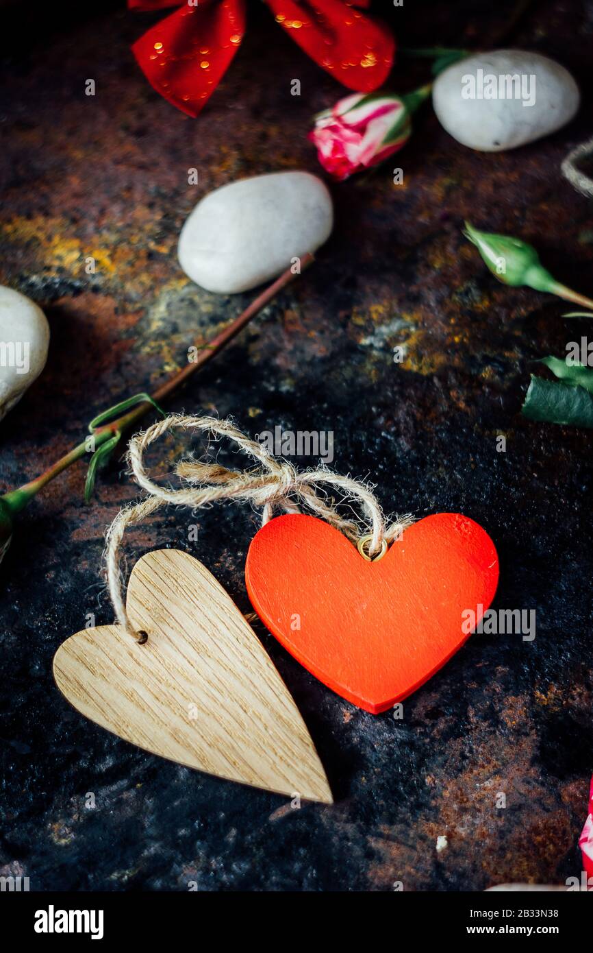Two bounded hearts on rustic background Stock Photo - Alamy