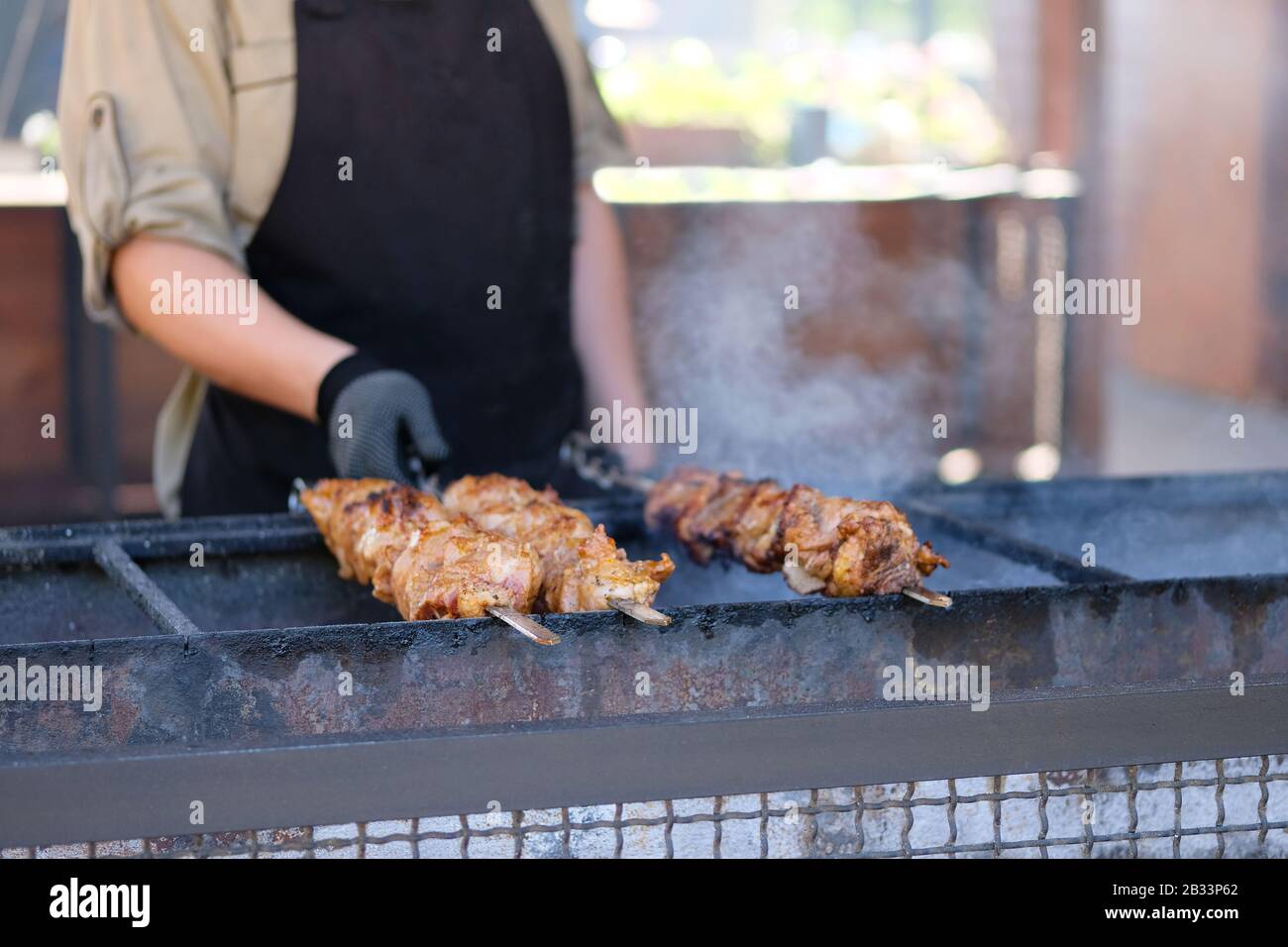 Black man cooking on a barbecue hi-res stock photography and images - Alamy