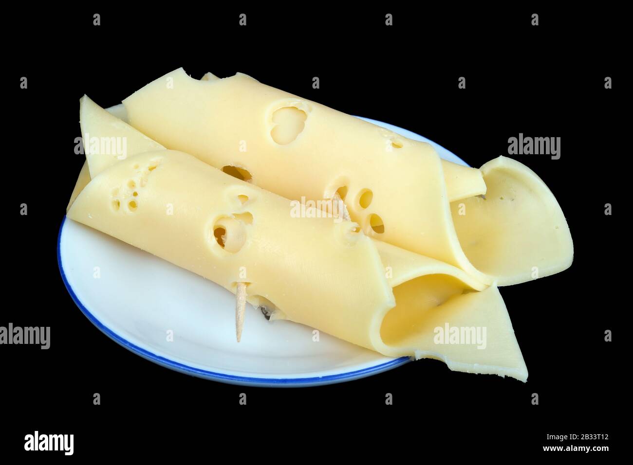 Two rolls of parmesan cheese lie on a white plate. Isolated on black ...