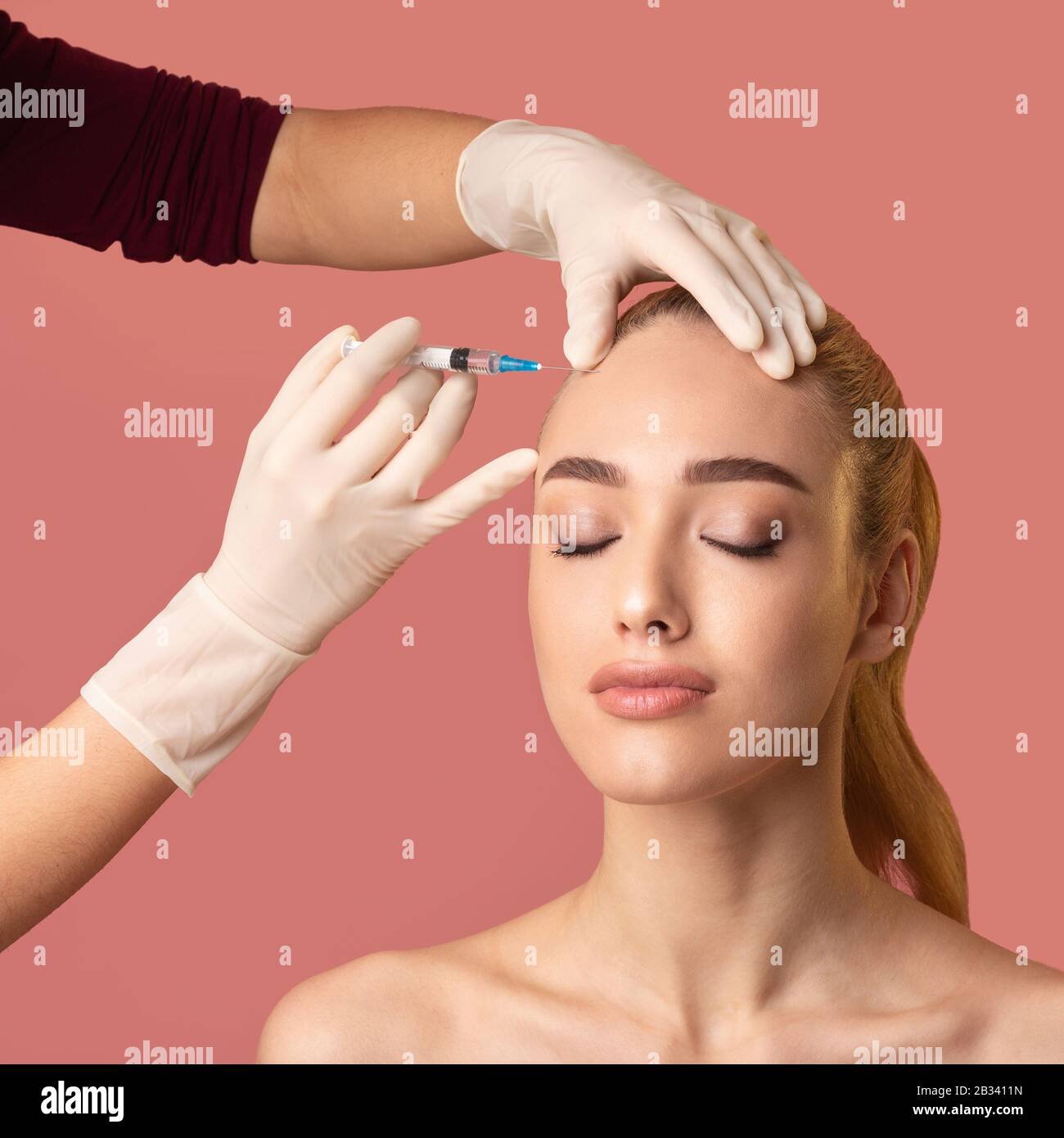 Woman Getting Beauty Injection In Forehead Smoothing Skin, Pink ...