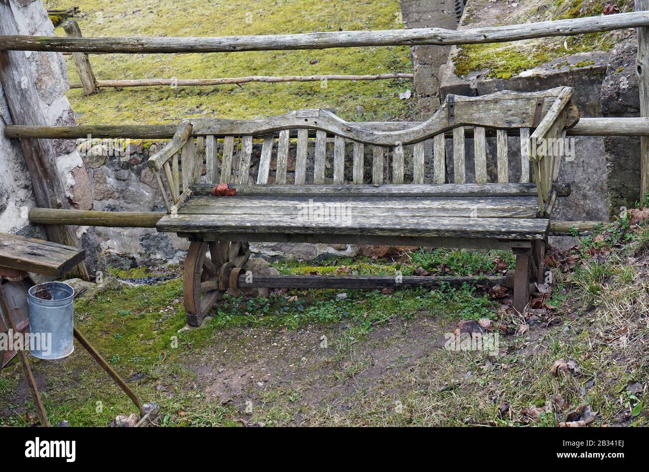 Oak aged rotten wooden rural bench for rest stand near rustic shed ...