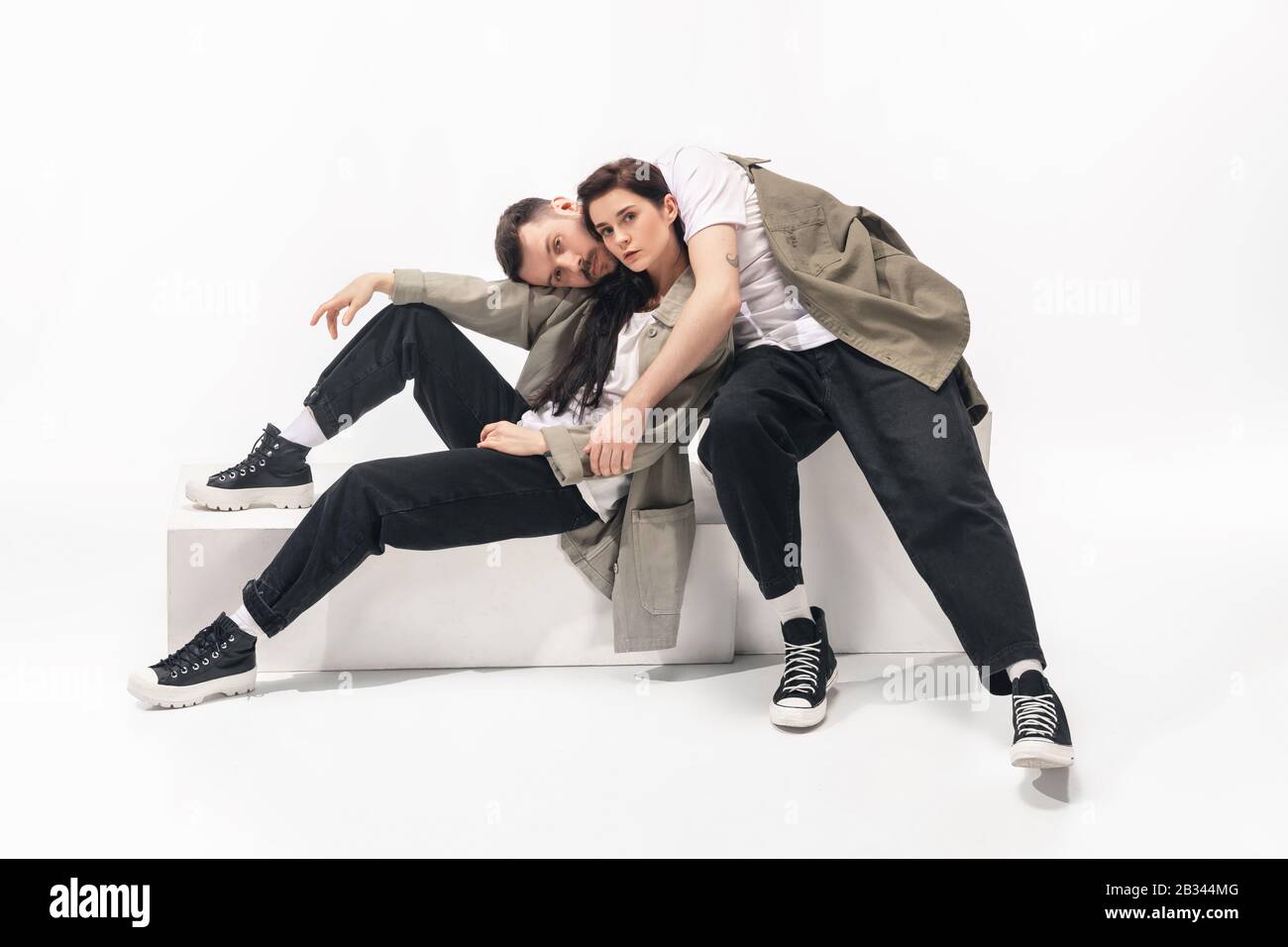 One whole. Trendy fashionable couple isolated on white studio ...