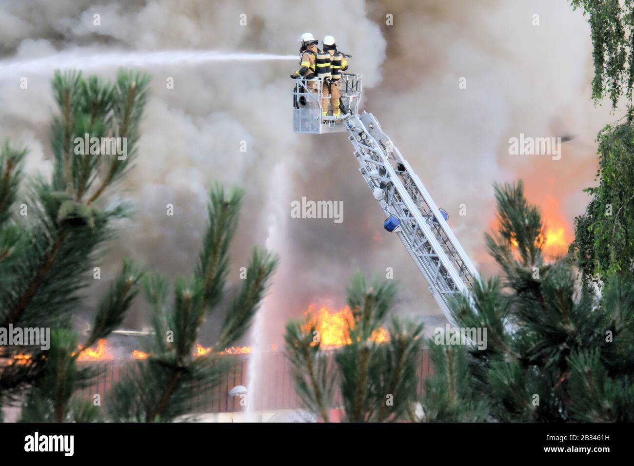 Firefighters trying to stop the fire surrounded by heavy smoke Stock ...