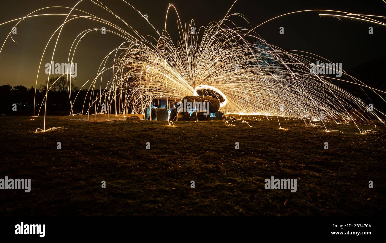 Steel wool spinning above the ground and rocks during the night Stock ...