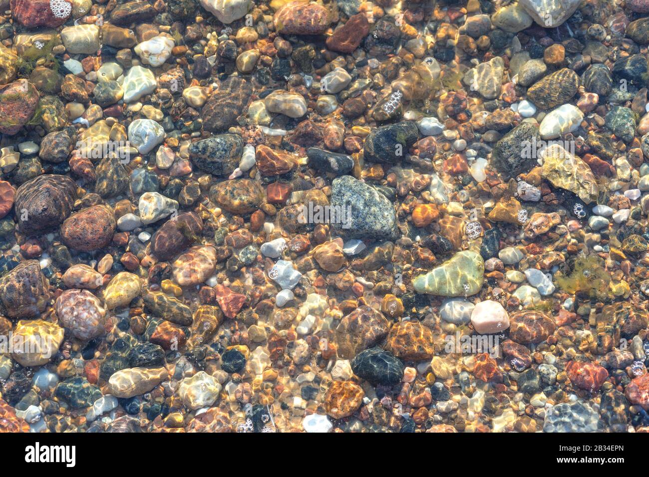 Background of stones on a sandy seabed Stock Photo - Alamy