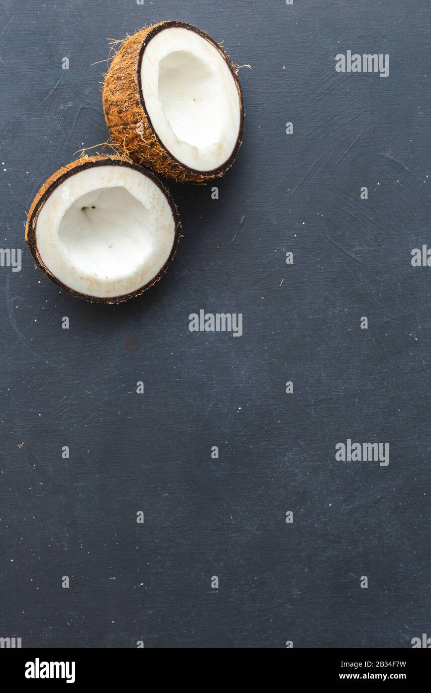 Vertical overhead shot of cut coconuts on a grey background - perfect ...