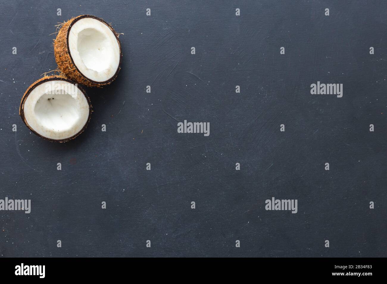 Overhead shot of cut coconuts on a grey background - perfect for ...