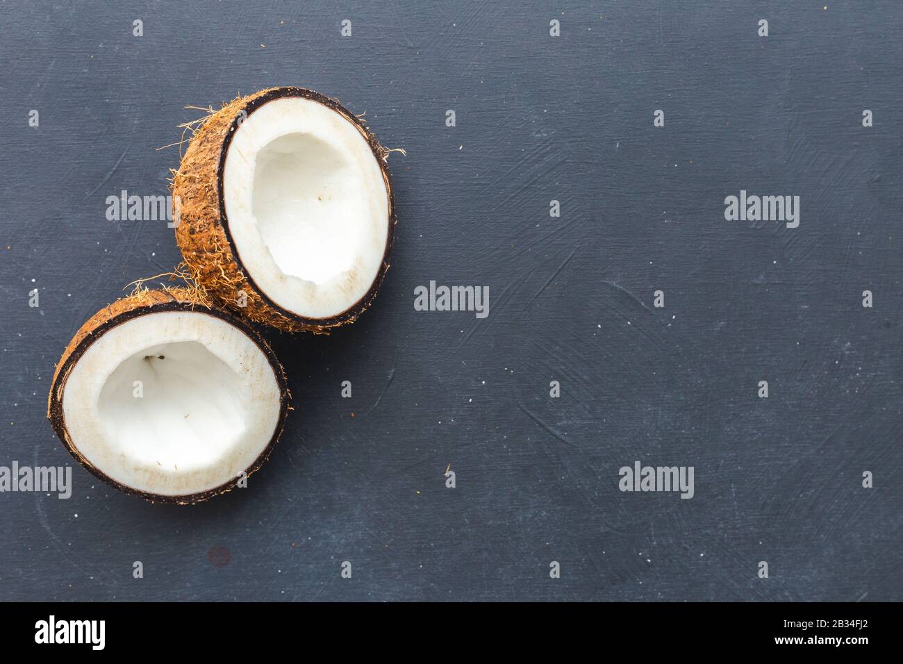Overhead closeup shot of cut coconuts on a grey background - perfect ...