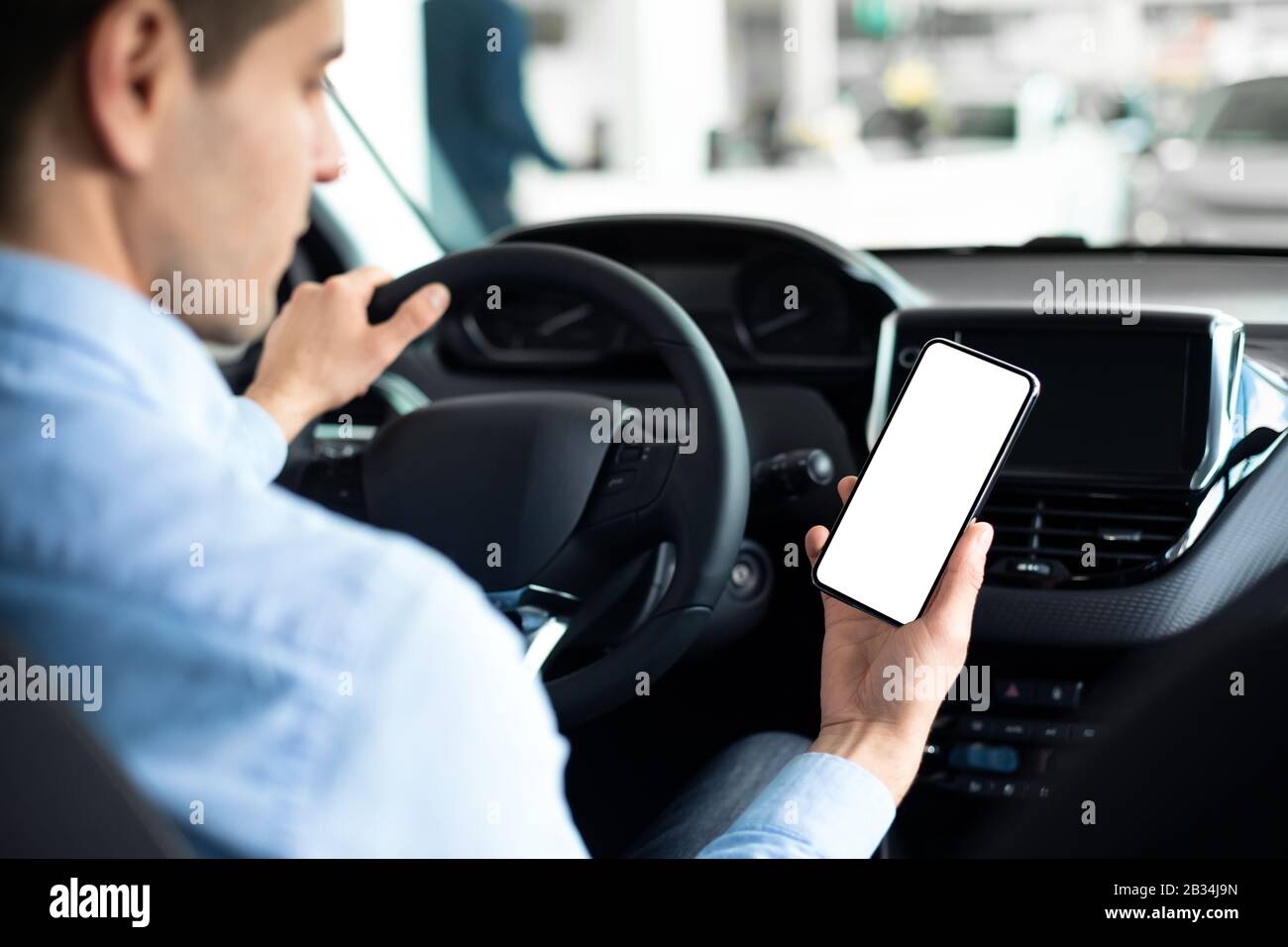 Man drive car using gadget hi-res stock photography and images - Alamy