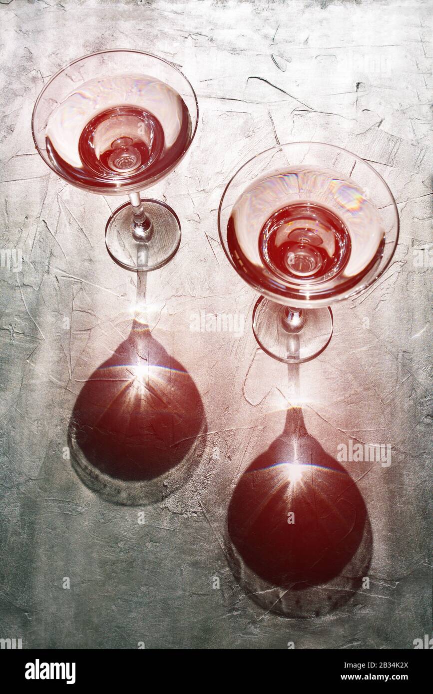 Cocktail glasses and sunlight. Reflection from glass goblets on a ...