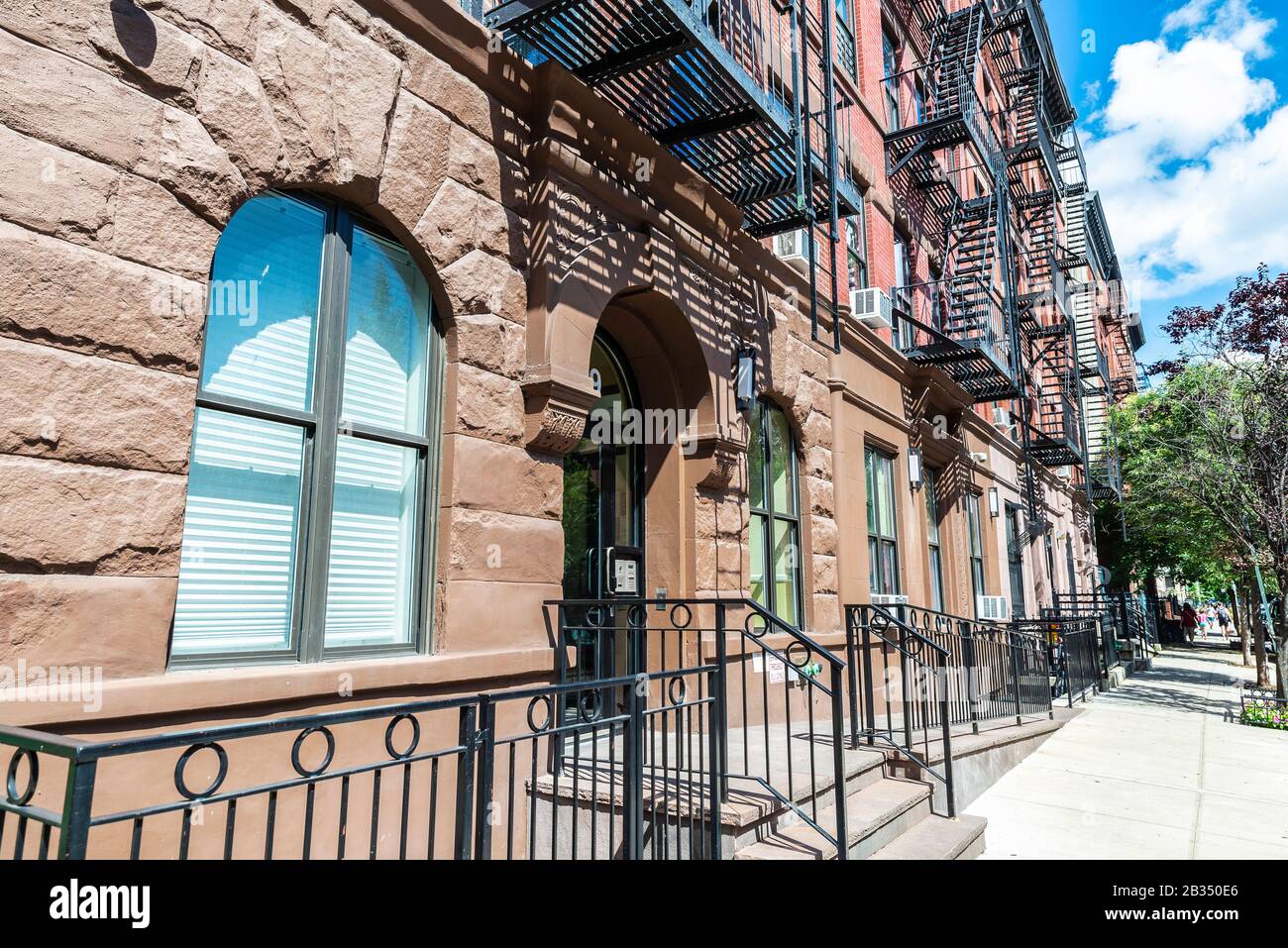 Old typical houses with its fire escape in the Harlem neighborhood in ...