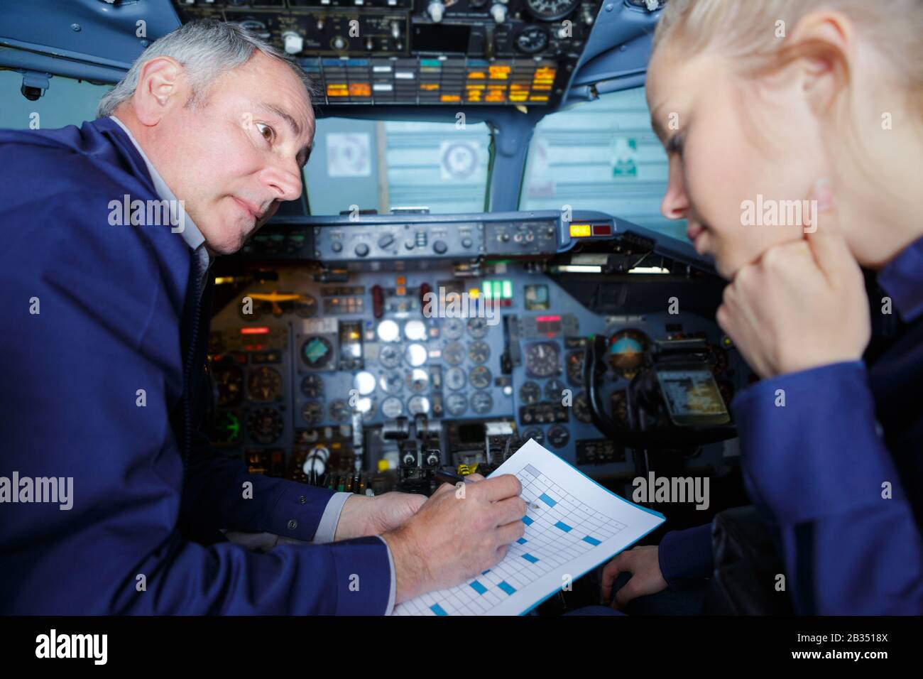 helicopter technical apprentice and teacher in cockpit Stock Photo - Alamy