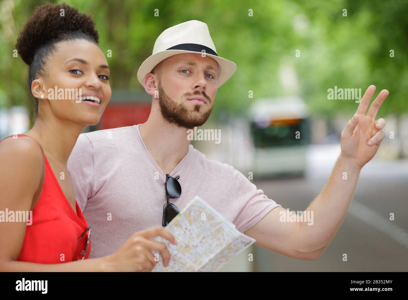 couple hailing for transport Stock Photo - Alamy