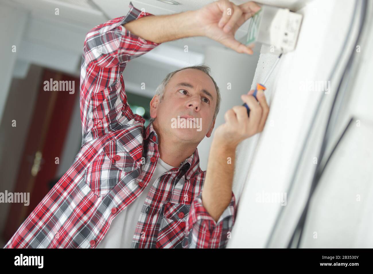 man fixing sign Stock Photo - Alamy