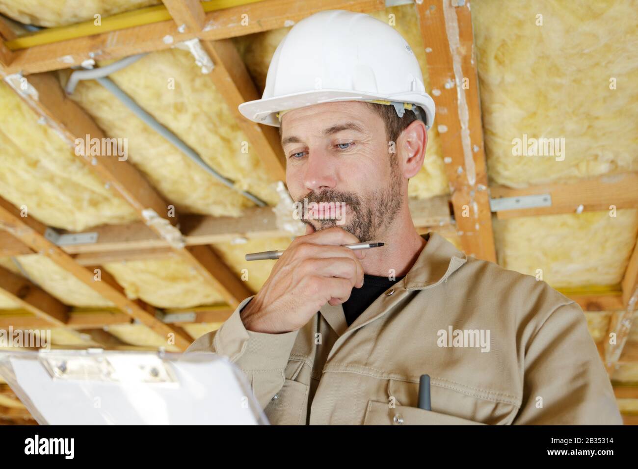 pensive man builder in hard hat Stock Photo - Alamy