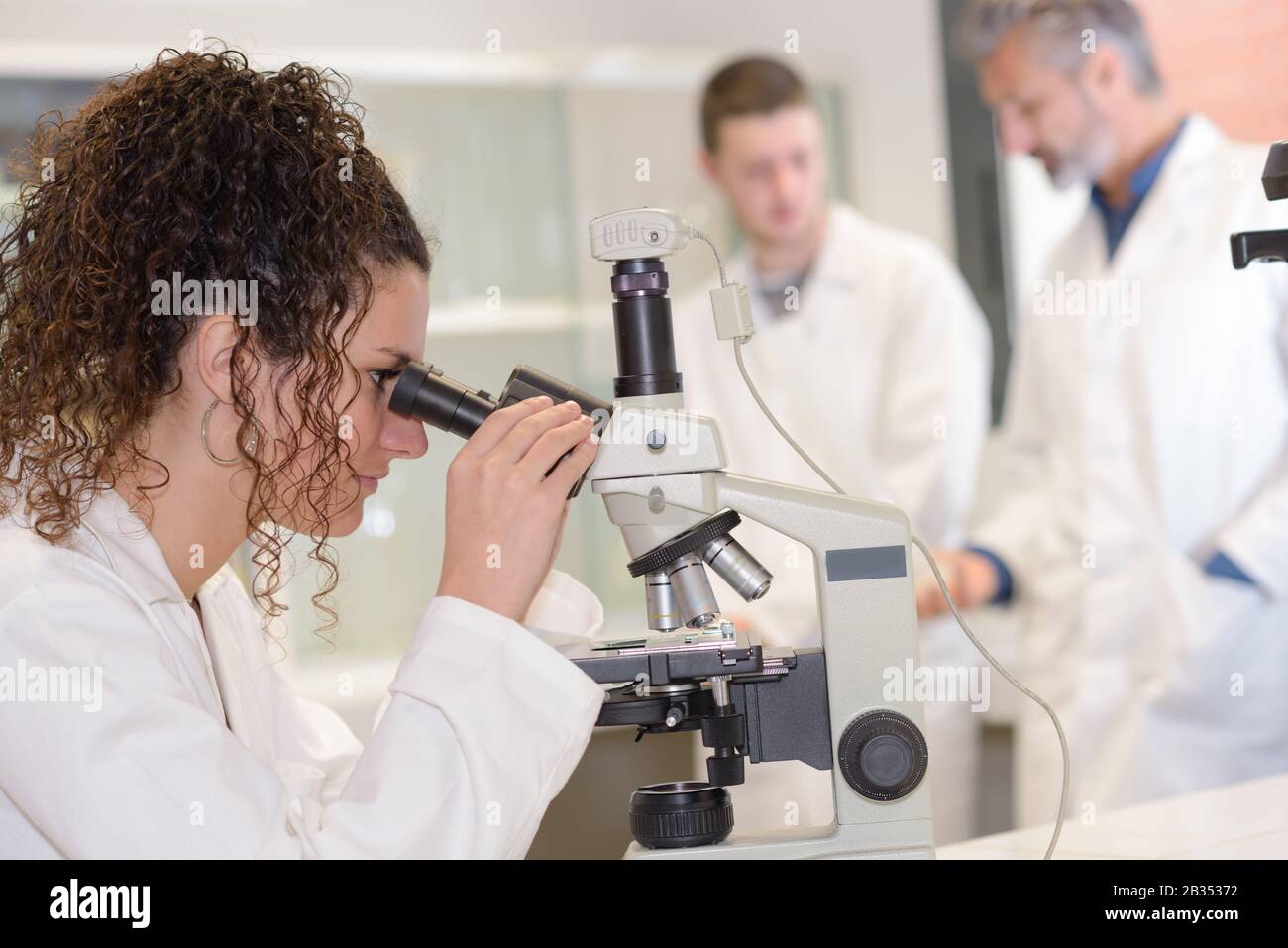 female scientist using a microscope Stock Photo - Alamy