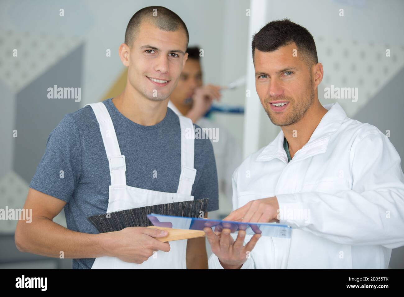 a renovation contractor and learner posing Stock Photo - Alamy