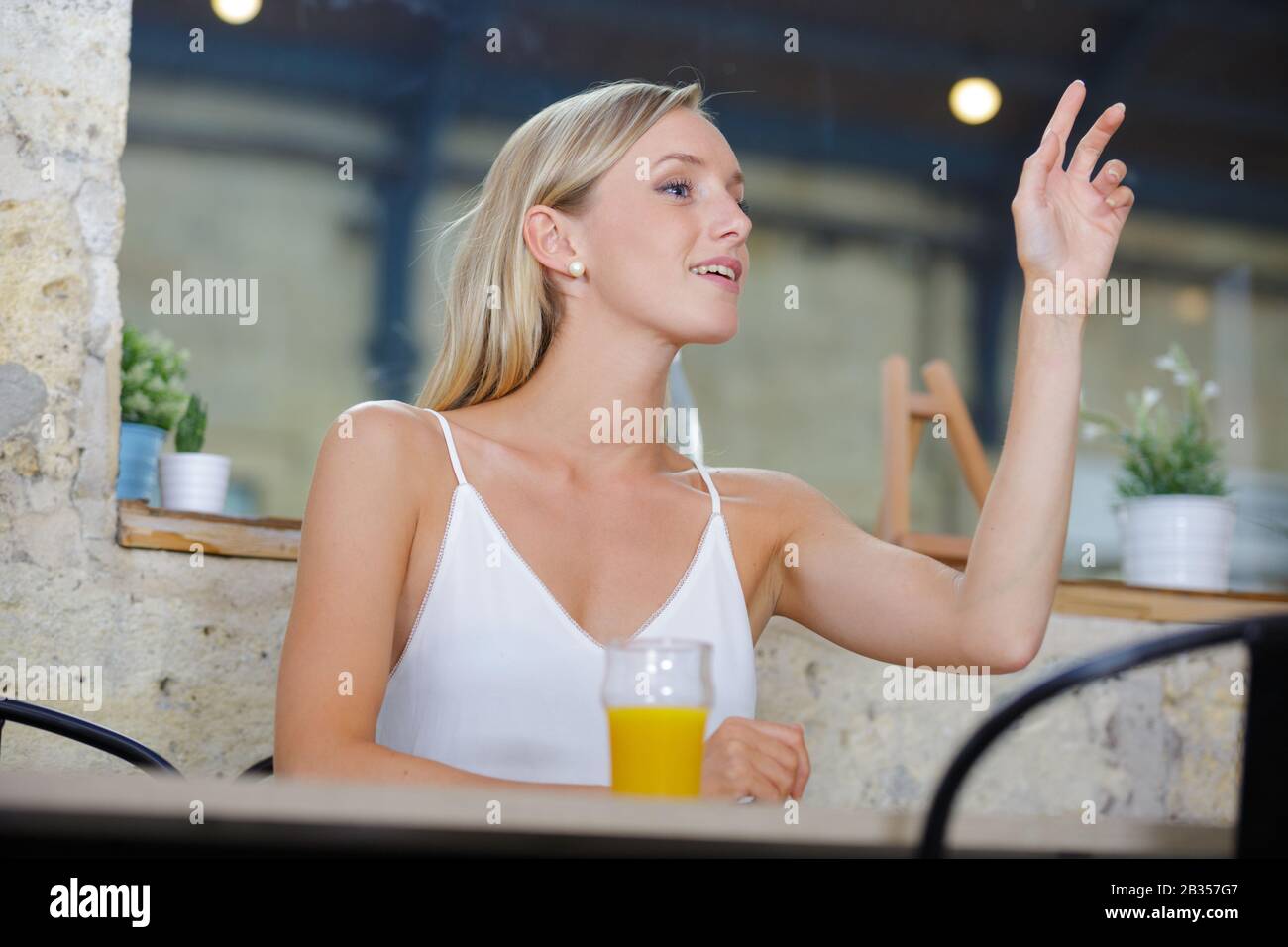 Woman calling waiter hi-res stock photography and images - Alamy
