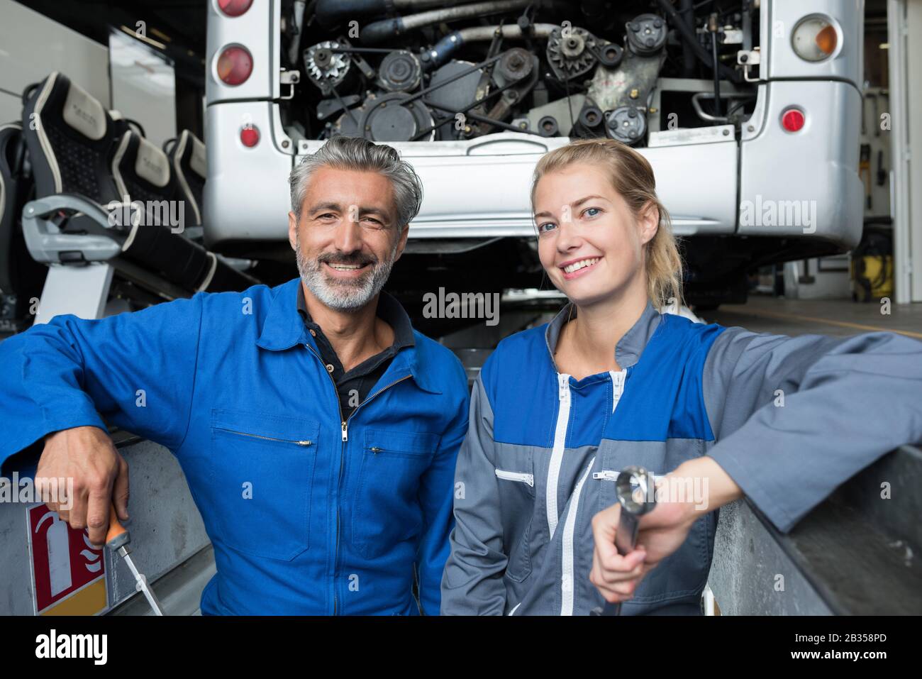 man and woman in auto repair shop Stock Photo - Alamy