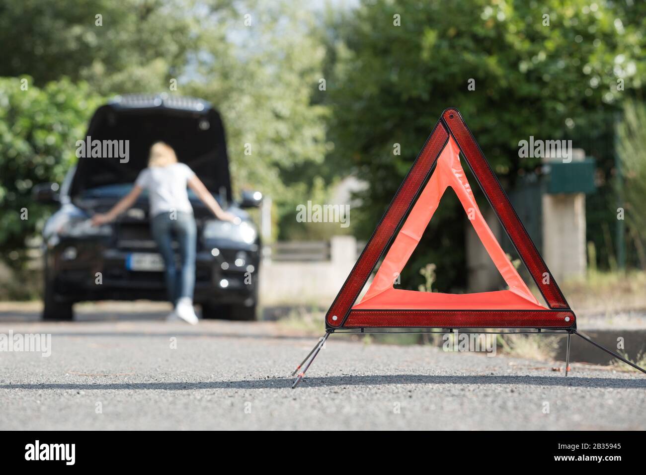 emergency stop sign and broken car on the road Stock Photo - Alamy