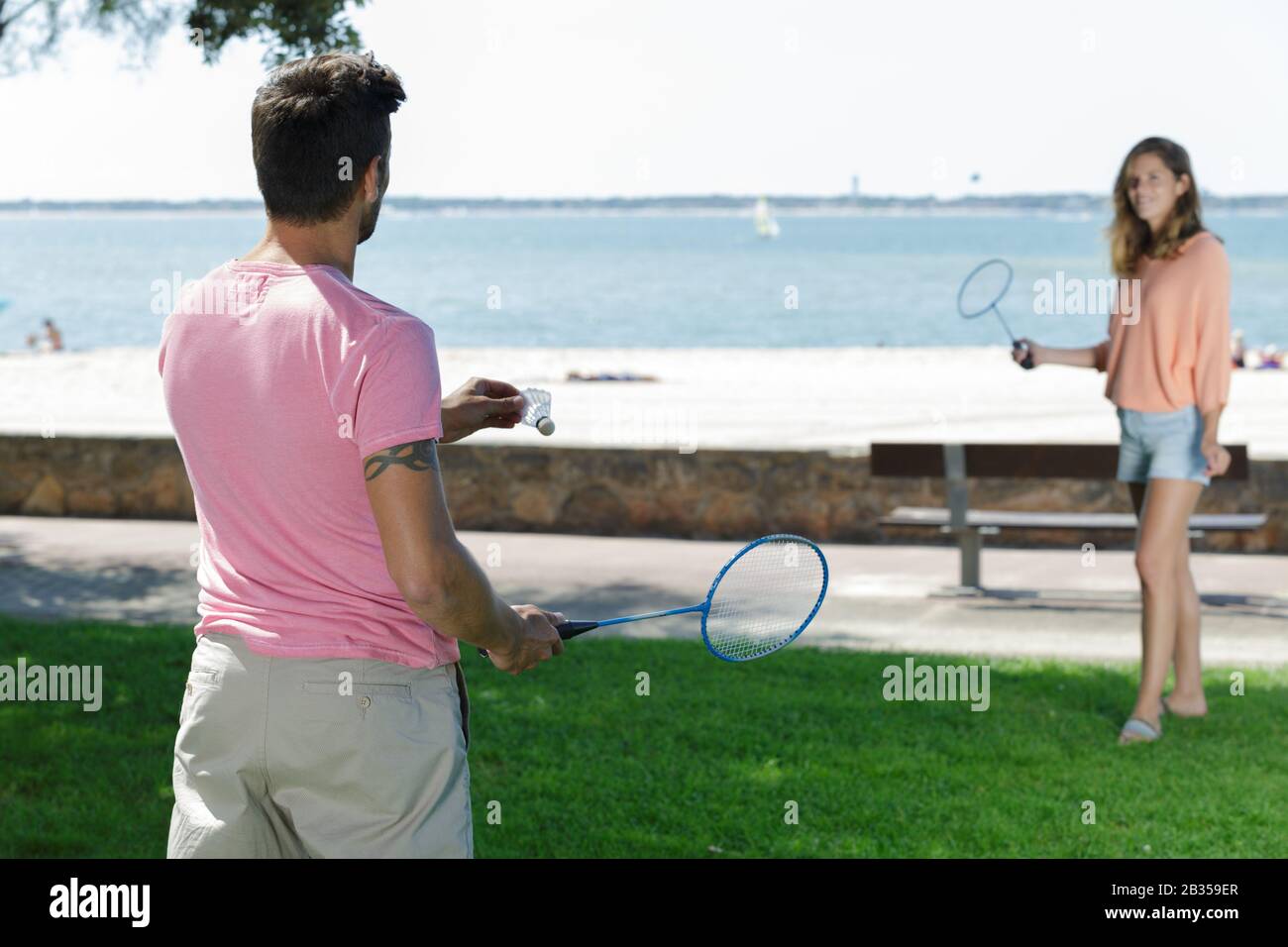 group of friends playing badminton in the beach Stock Photo - Alamy