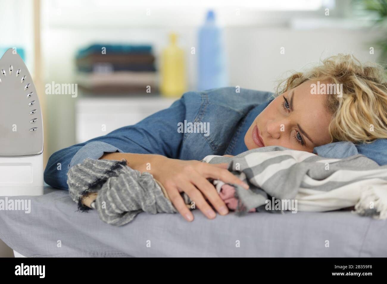 sad housewife with laundry next to washing machine Stock Photo - Alamy