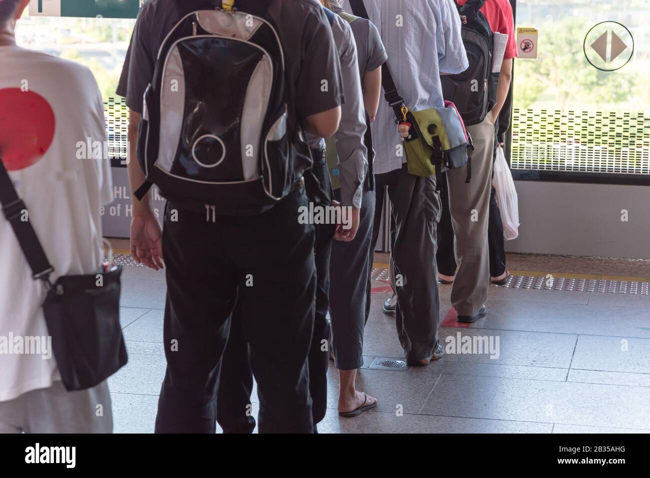 Diverse people waiting in line at MRT Mass Rapid Transit train station ...