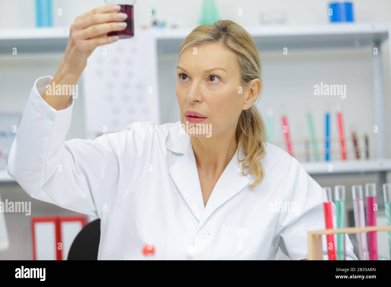 Woman checking test tubes scientist hi-res stock photography and images ...