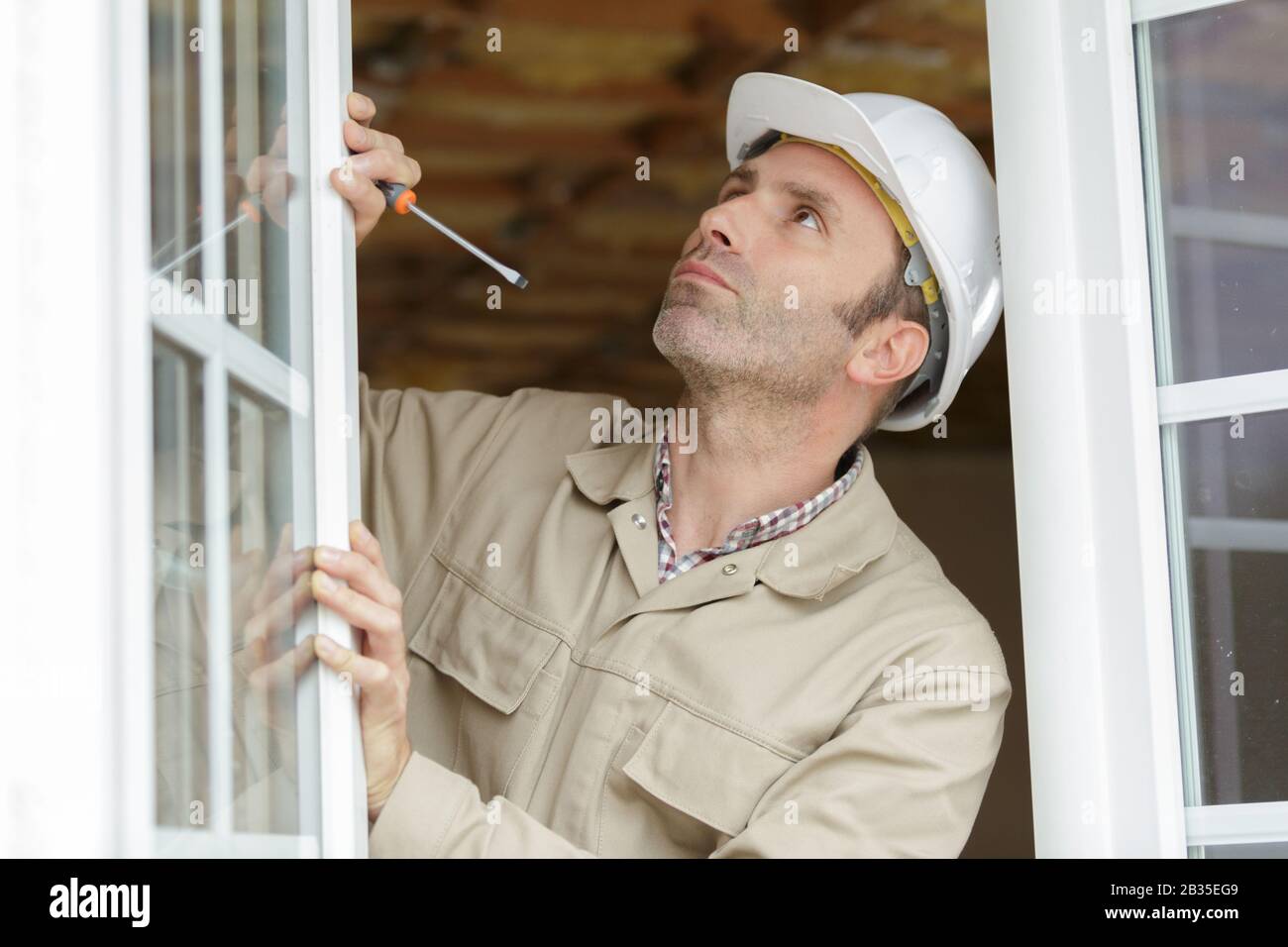 window builder working on mount of new installation Stock Photo - Alamy