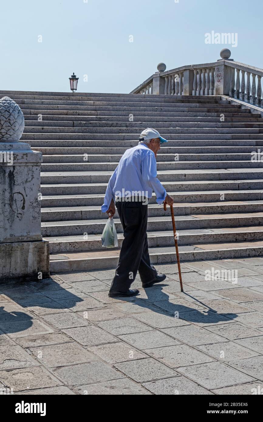 Old man with a walking stick, Venice, Italy Stock Photo - Alamy