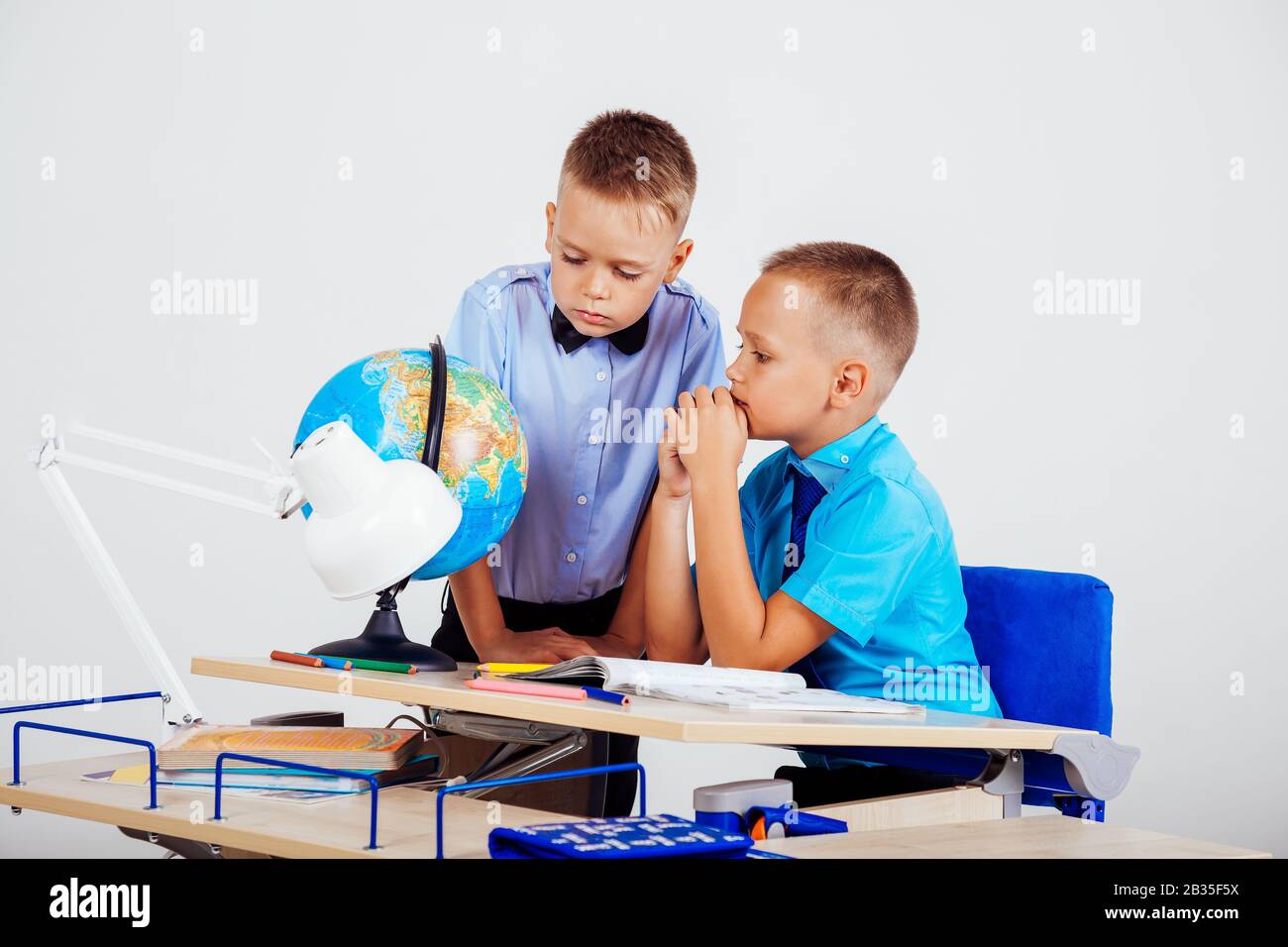 boys schoolchildren in class at a desk in the classroom at school Stock ...
