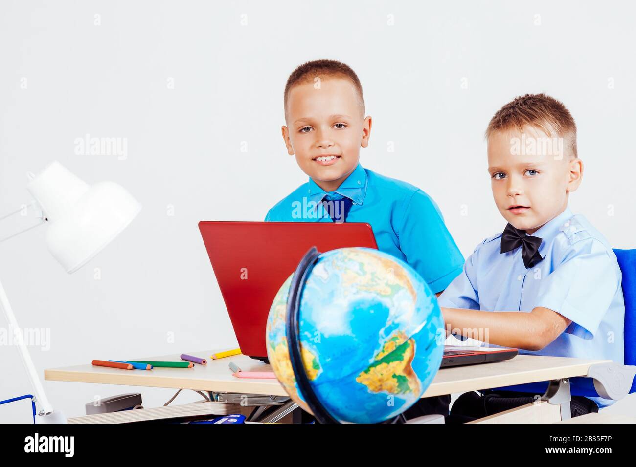 boys schoolchildren in class at a desk in the classroom at school Stock ...