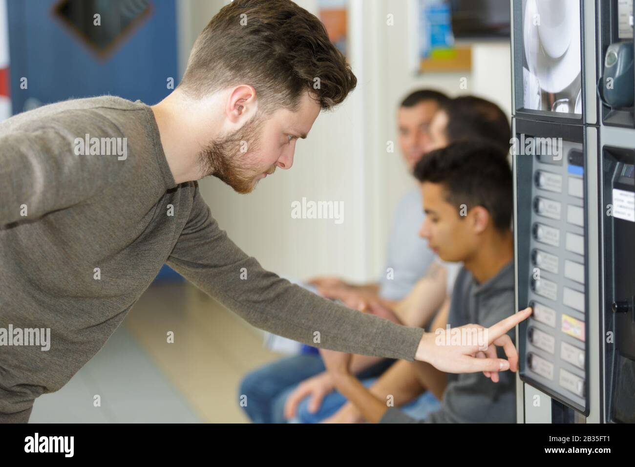 man inserting euro coin to vending machine money slot Stock Photo - Alamy