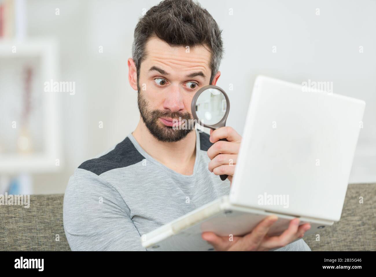 man investigating an article in the internet Stock Photo - Alamy