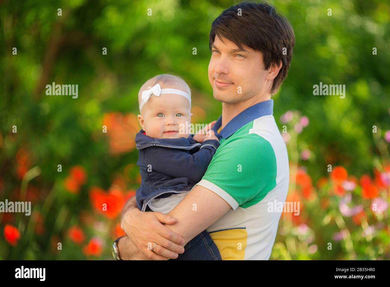 Happy father and child playing together on the poppy meadow. Dad and ...