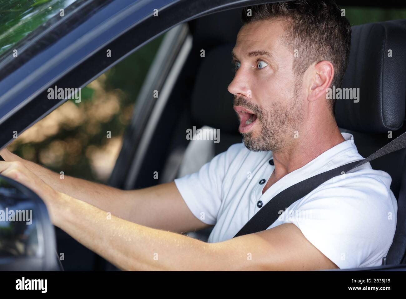 male driver with shocking expression on his face Stock Photo - Alamy