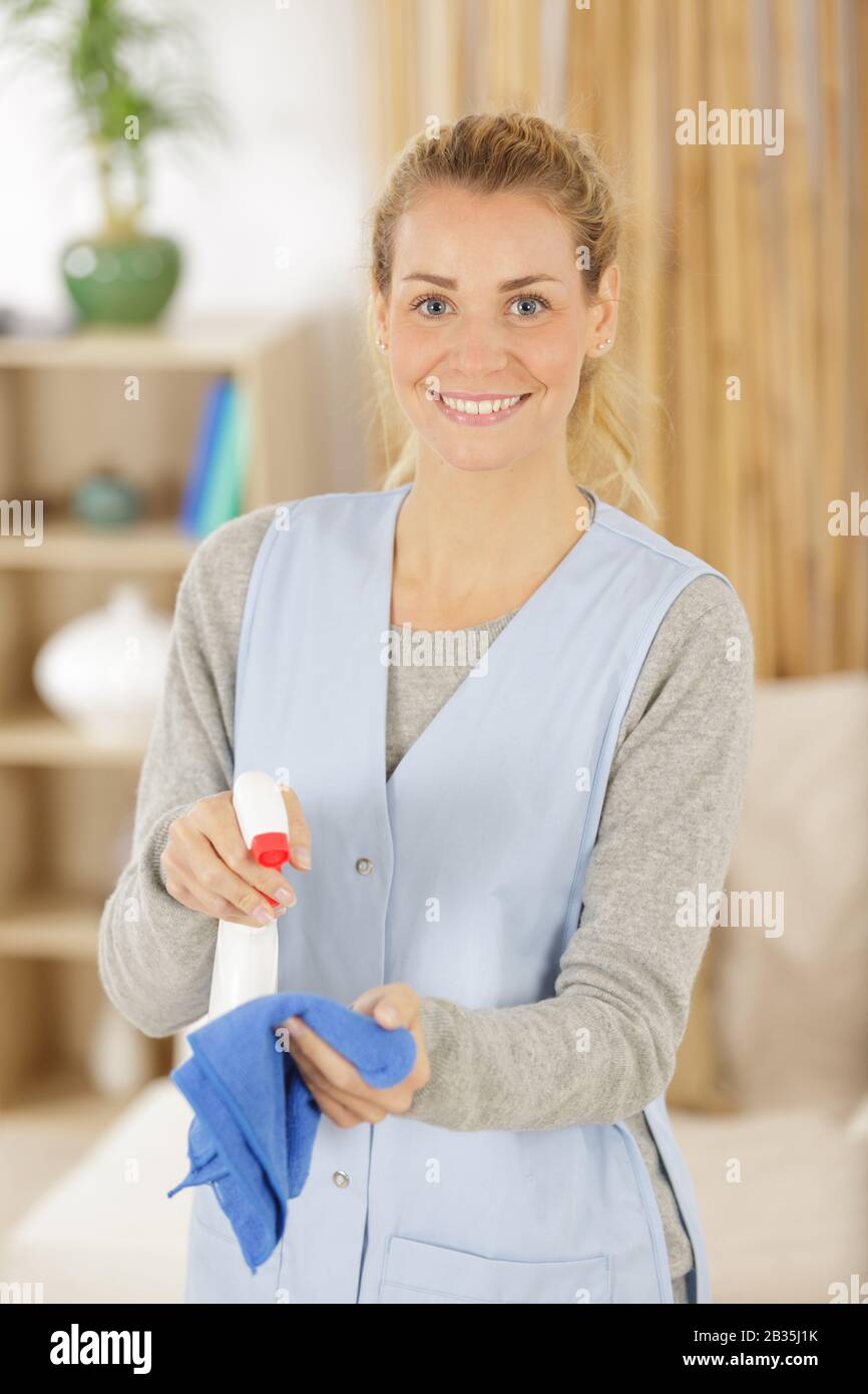 happy housekeeper using a spray detergent Stock Photo - Alamy