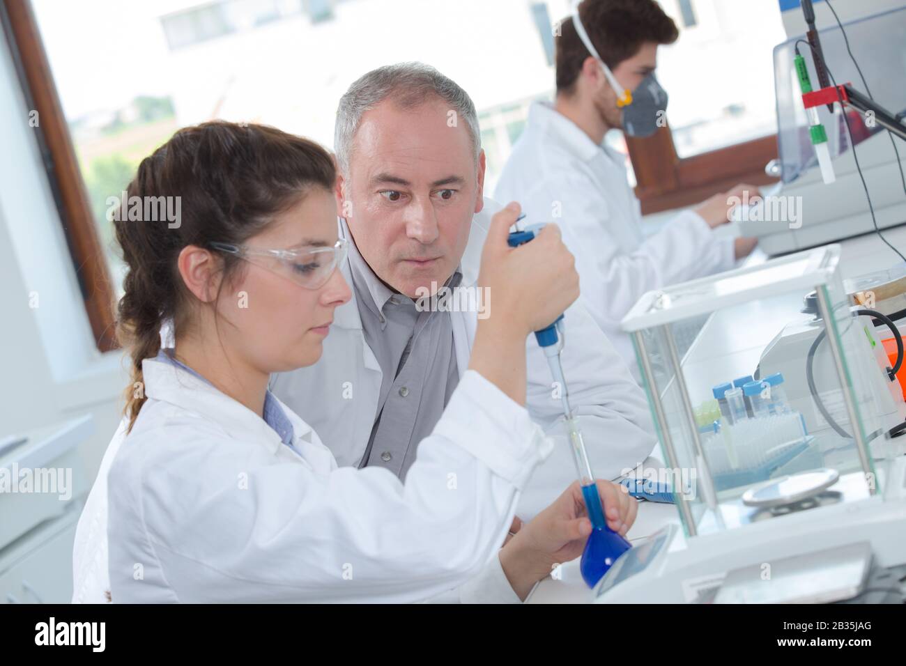 young female student with male professor in lab Stock Photo - Alamy