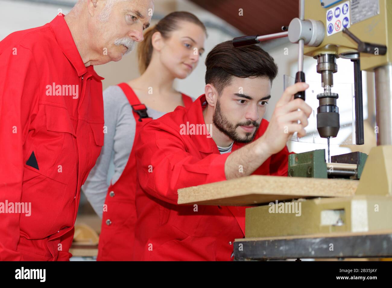 Young man using drill machine hi-res stock photography and images - Alamy