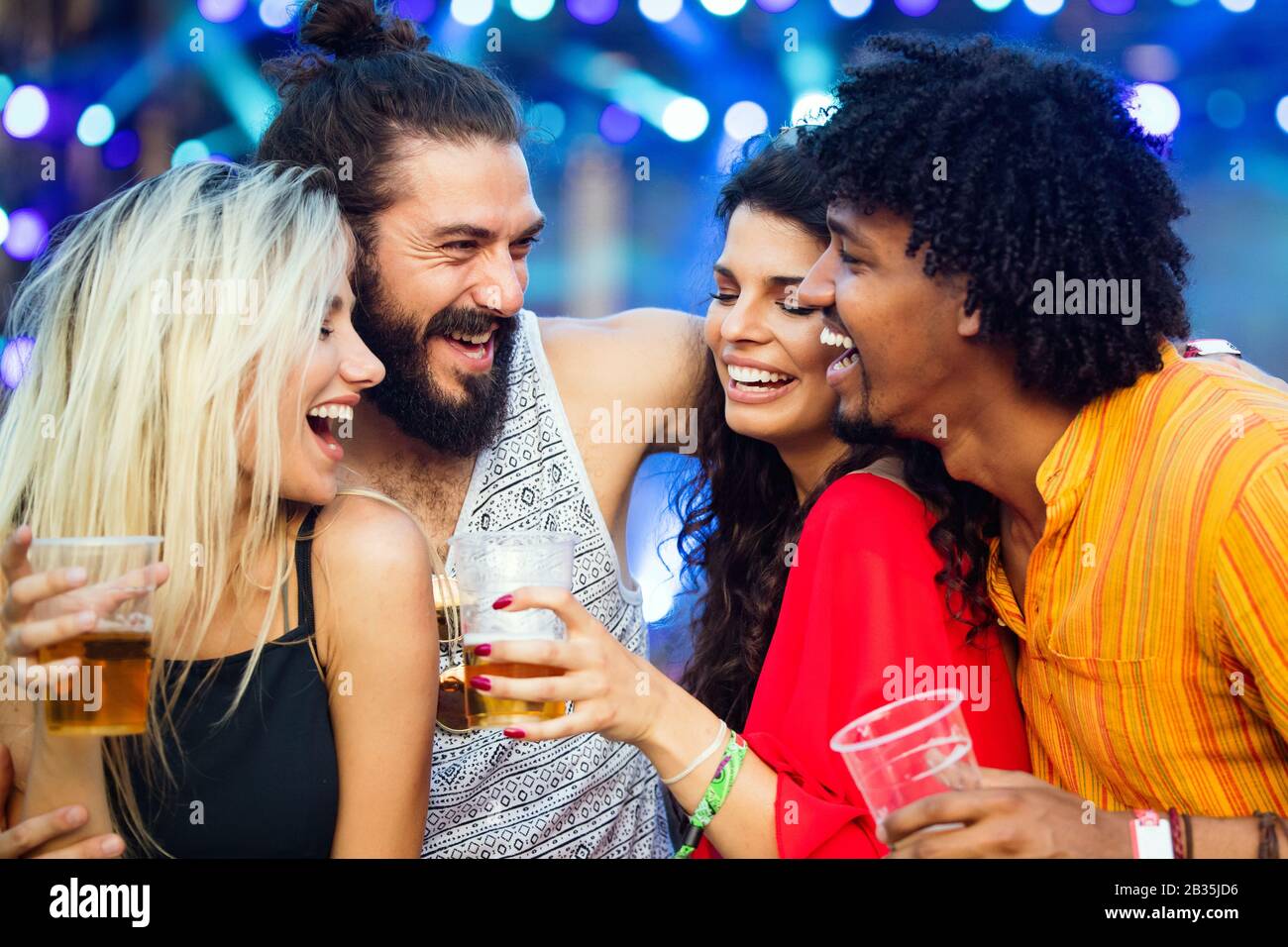 Group of happy friends hanging out and enjoying drinks, festival Stock ...