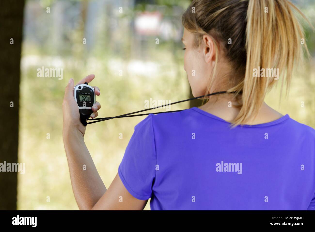 lady in sportswear holding stopwatch Stock Photo - Alamy
