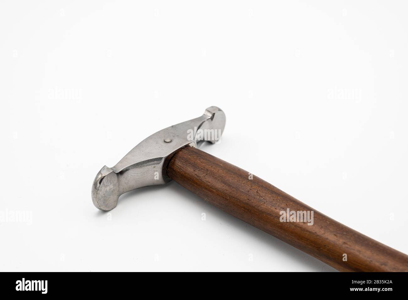 Closeup of a chasing hammer lying on a white background Stock Photo - Alamy