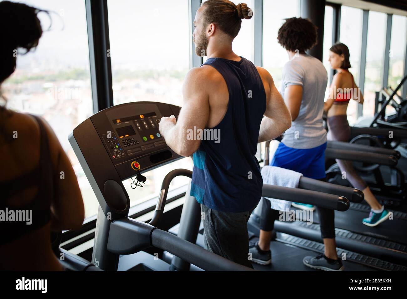 Picture of people running on treadmill in gym Stock Photo - Alamy