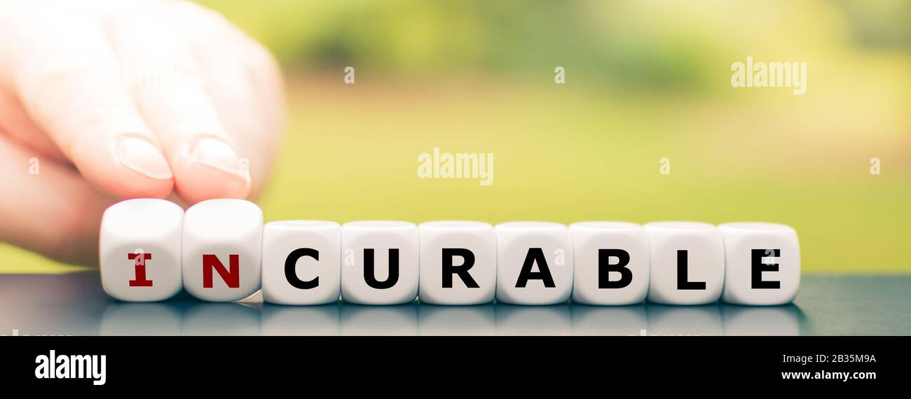 Hand turns dice and changes the word "incurable" to "curable Stock ...