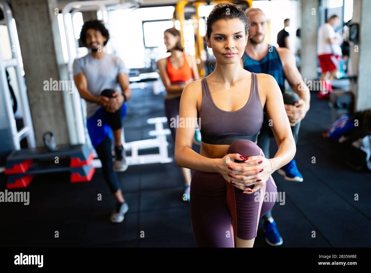 Attractive sports people are working out in gym Stock Photo - Alamy