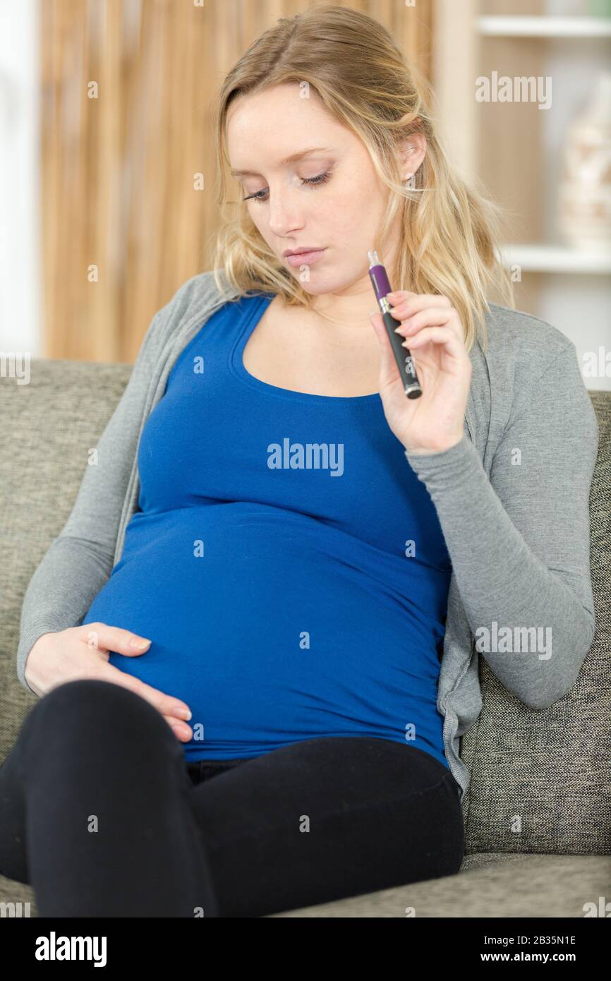 charming girl with baby in belly holding a e-cigarette Stock Photo - Alamy