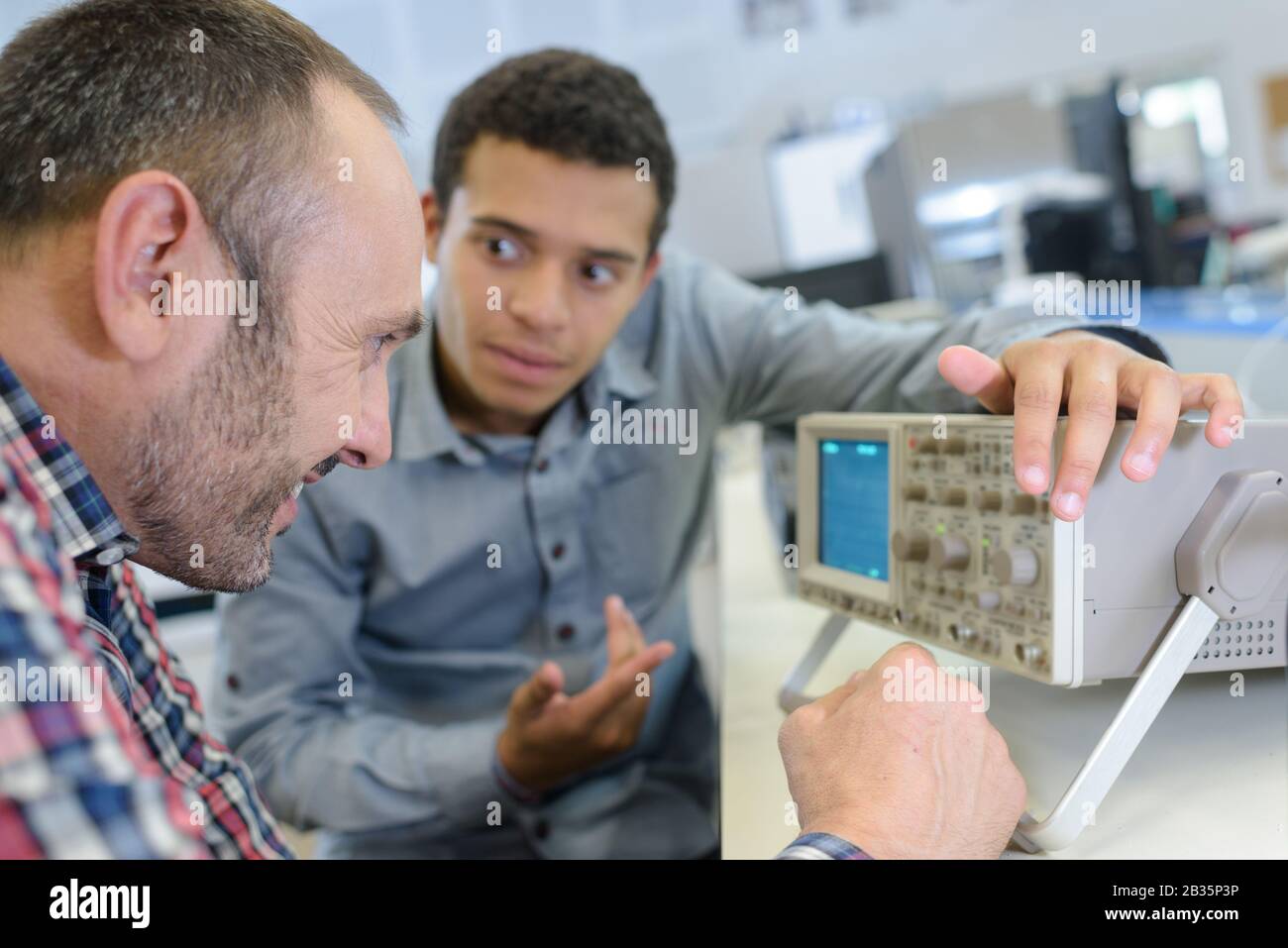 two men working with a radio Stock Photo - Alamy