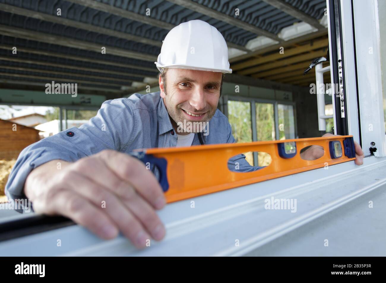 happy man using a level Stock Photo - Alamy